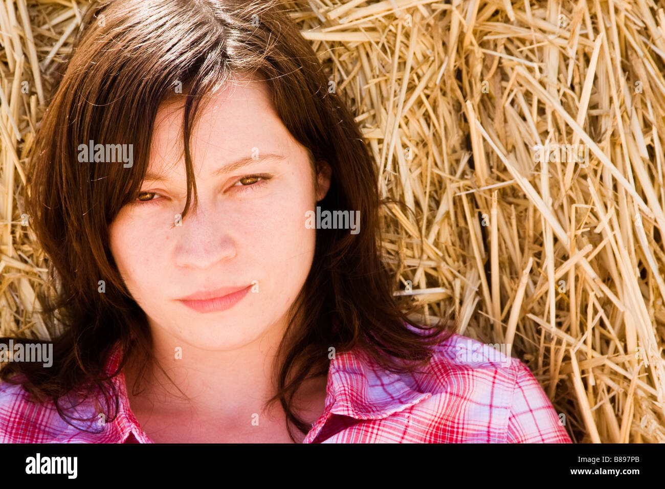 Young farmer resting on the haystack Stock Photo - Alamy