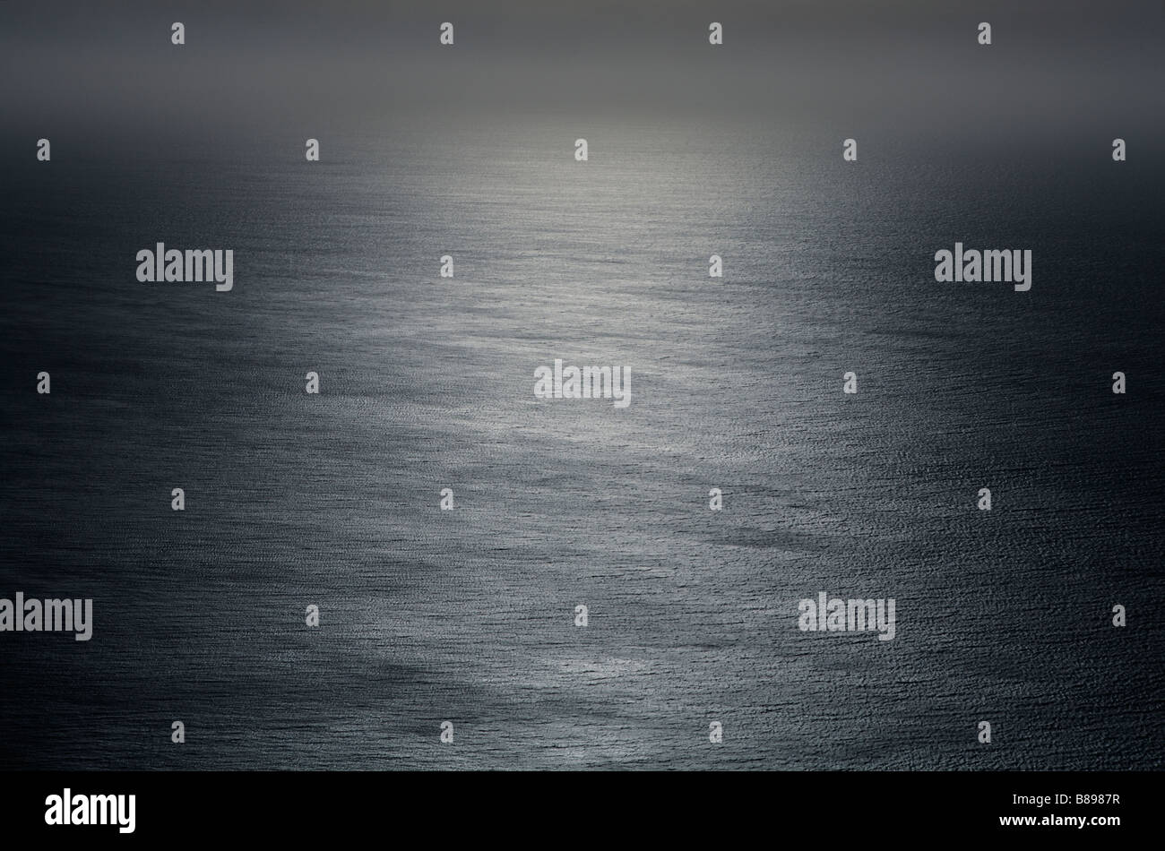 A dark brooding moody seascape gazing into distant sea fog Stock Photo ...