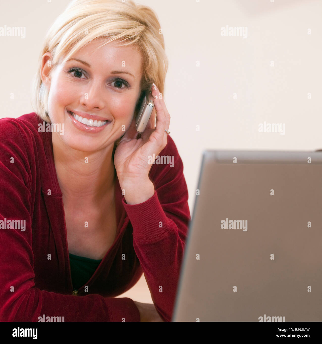 Beautiful woman on her cell phone with a laptop computer Stock Photo ...