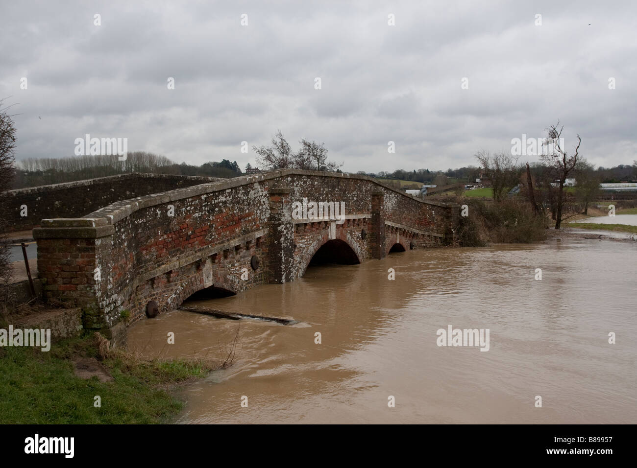 The River Rother flowing under a bridge near Bodiam Castle, East Sussex ...