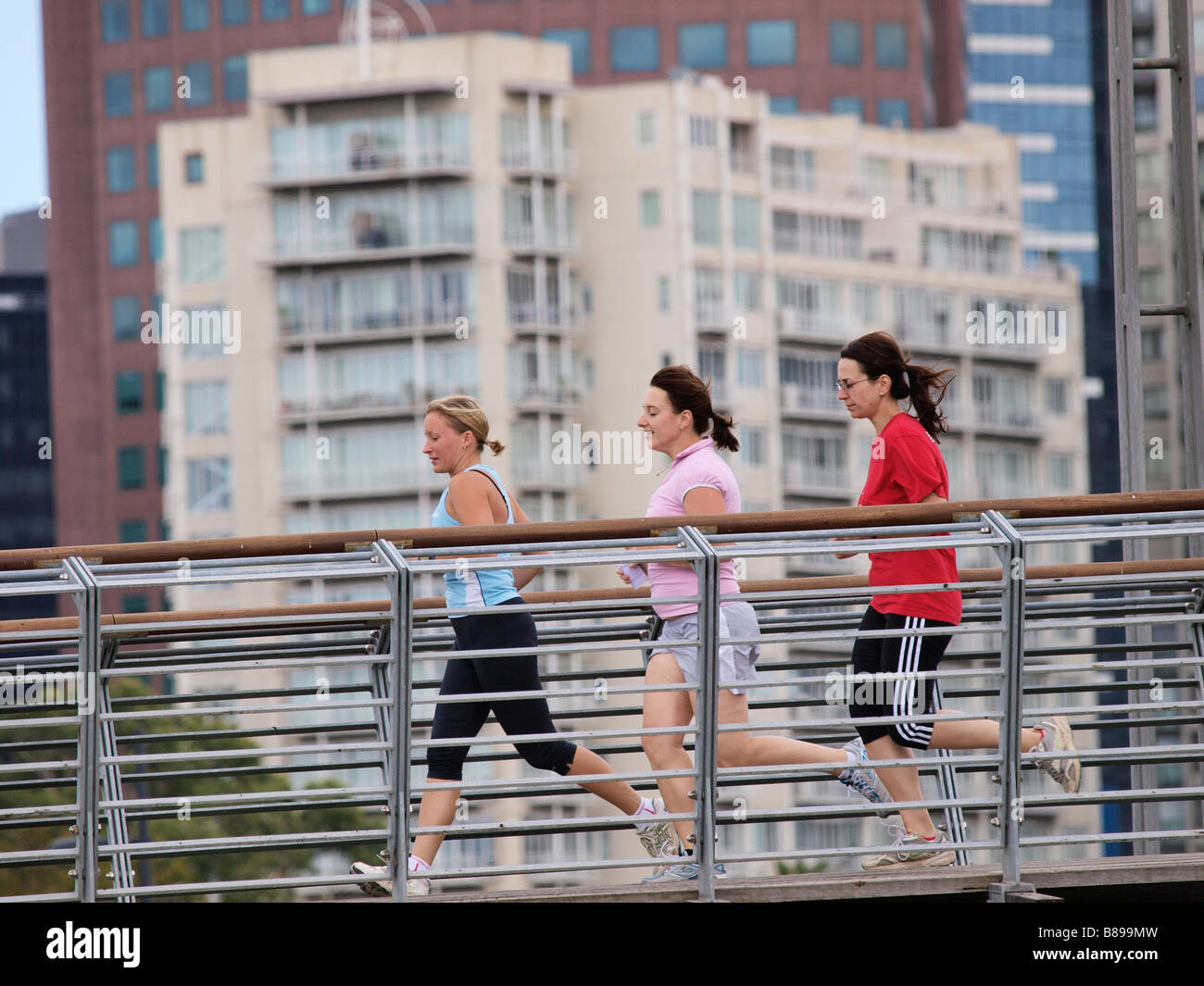 Woman running across street hi-res stock photography and images - Alamy