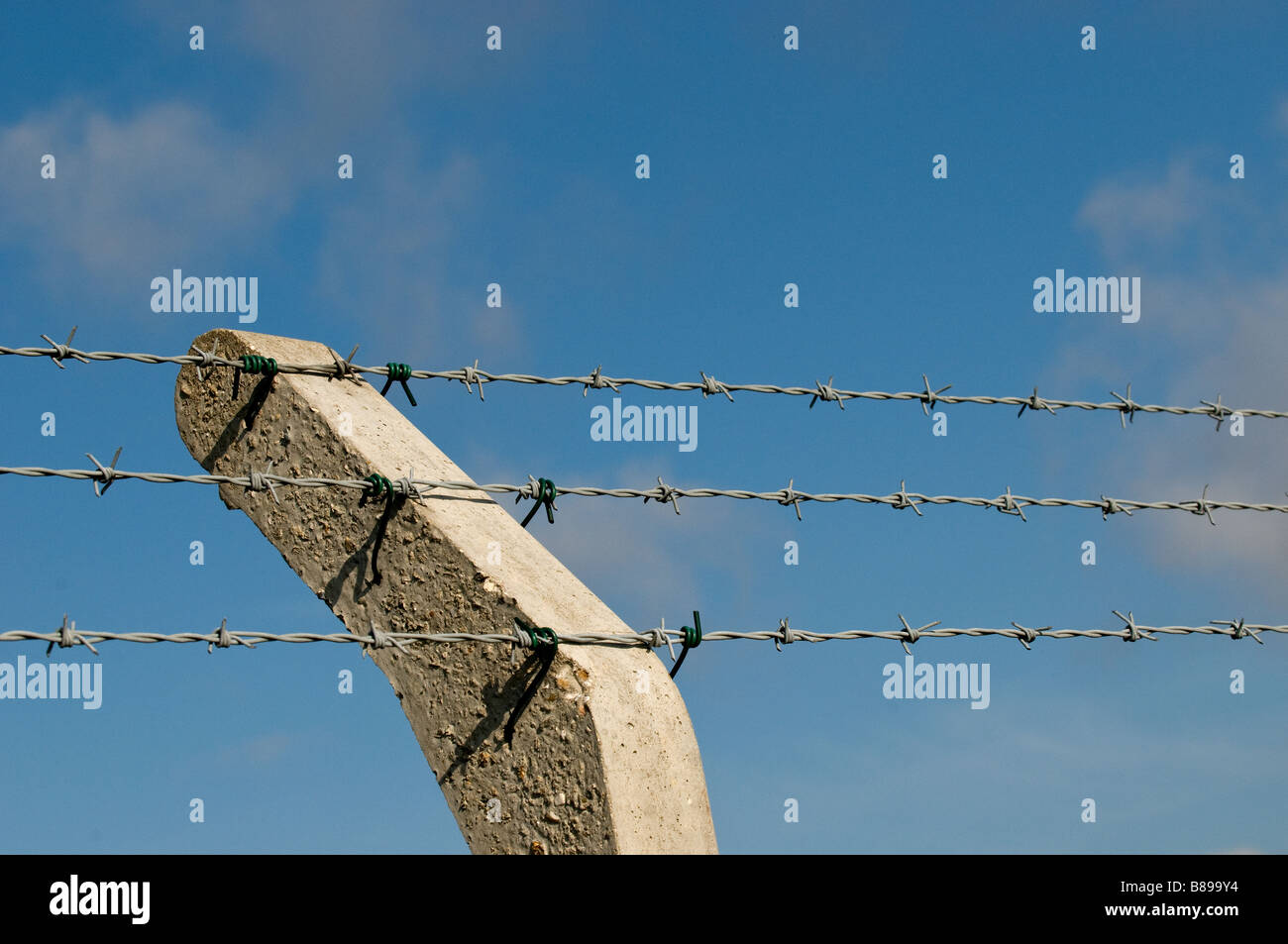 The concrete post of a security fence Stock Photo - Alamy