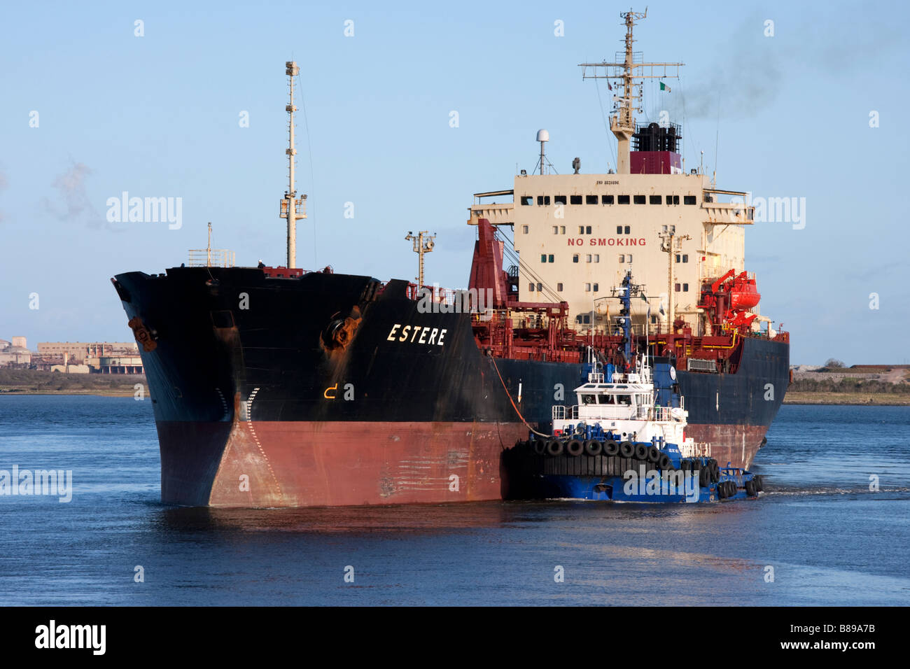 Tugboat pushing cargo ship in Foynes Harbour, County Limerick Ireland ...