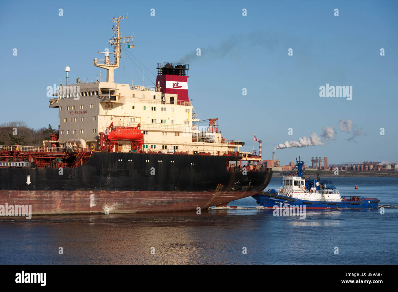 Tugboat pushing cargo ship in Foynes Harbour, County Limerick Ireland ...