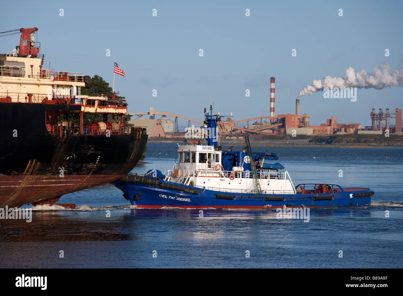 Tugboat pushing cargo ship in Foynes Harbour, County Limerick Ireland ...