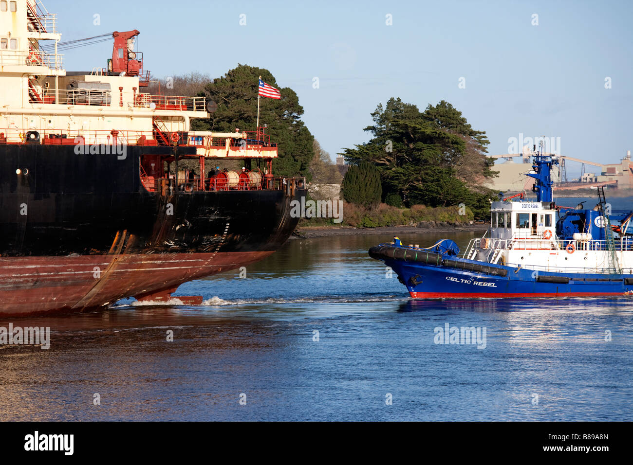 Tugboat pushing cargo ship in Foynes Harbour, County Limerick Ireland ...