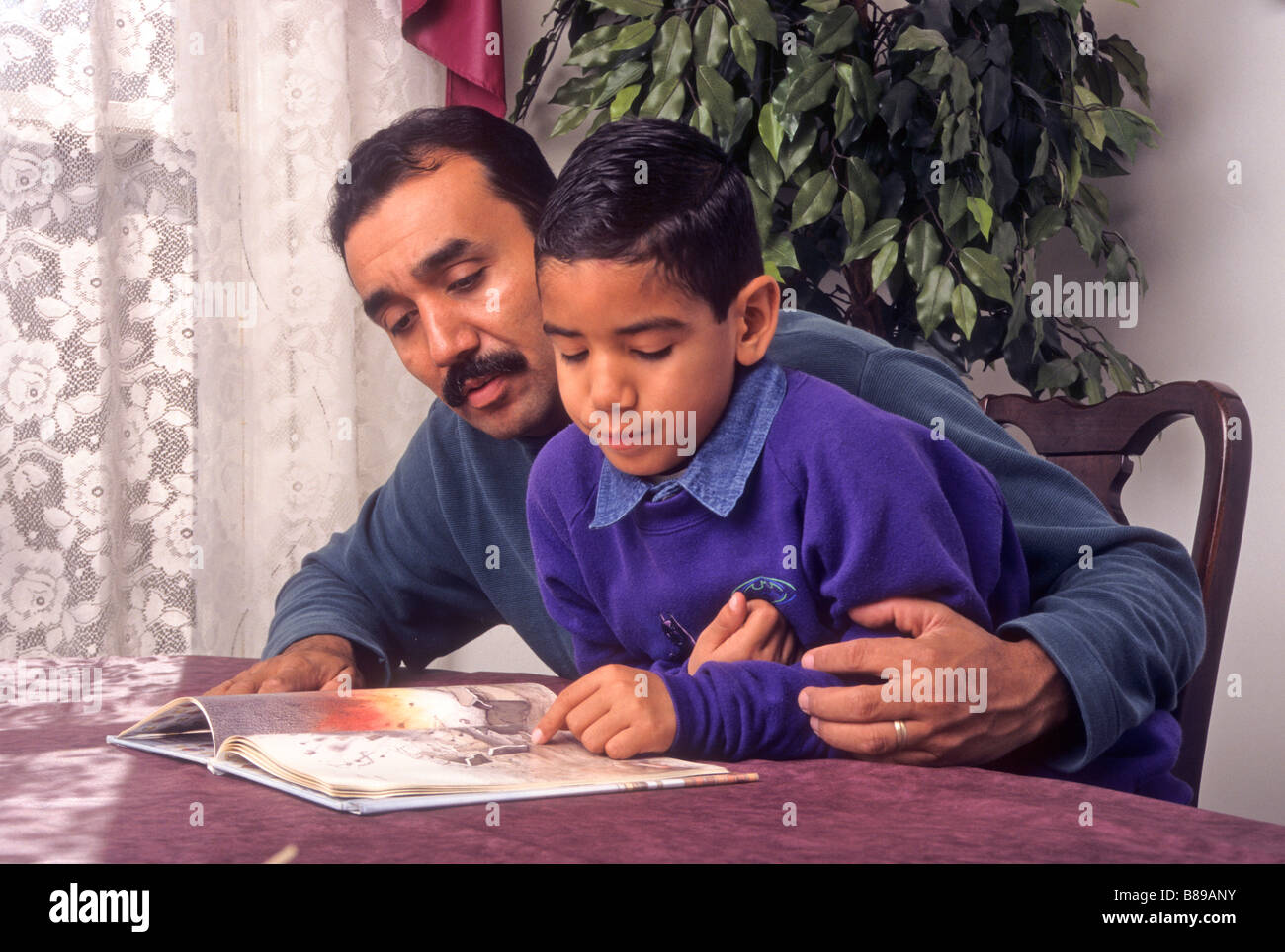 Hispanic father helps son do school homework love share teach Stock ...