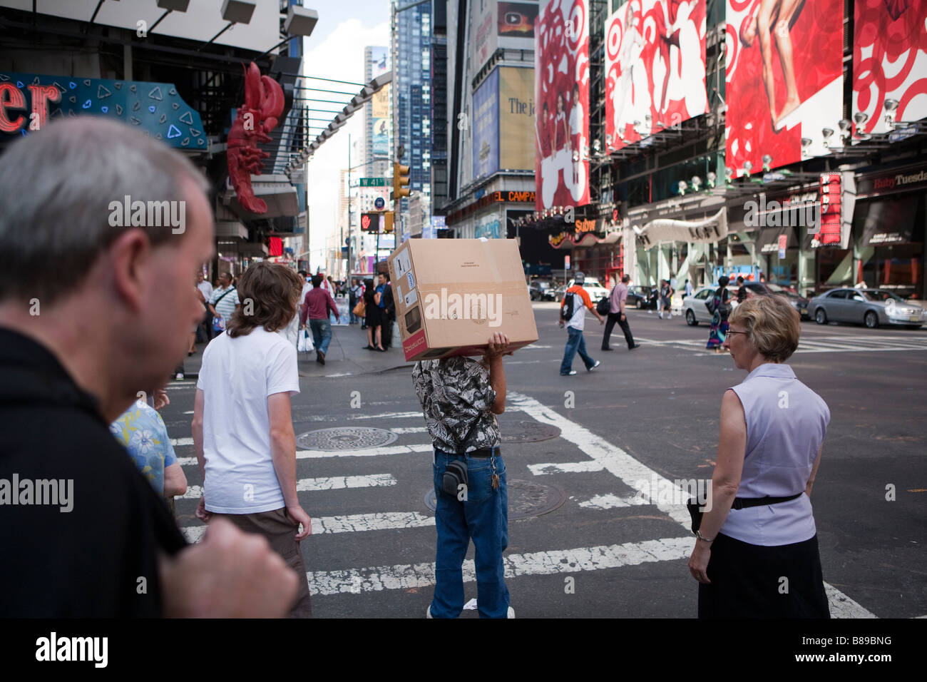 man walking on the street caring a box Stock Photo - Alamy