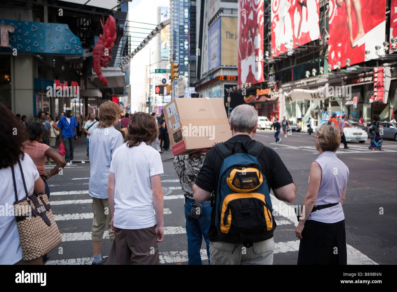 man walking on the street caring a box Stock Photo - Alamy