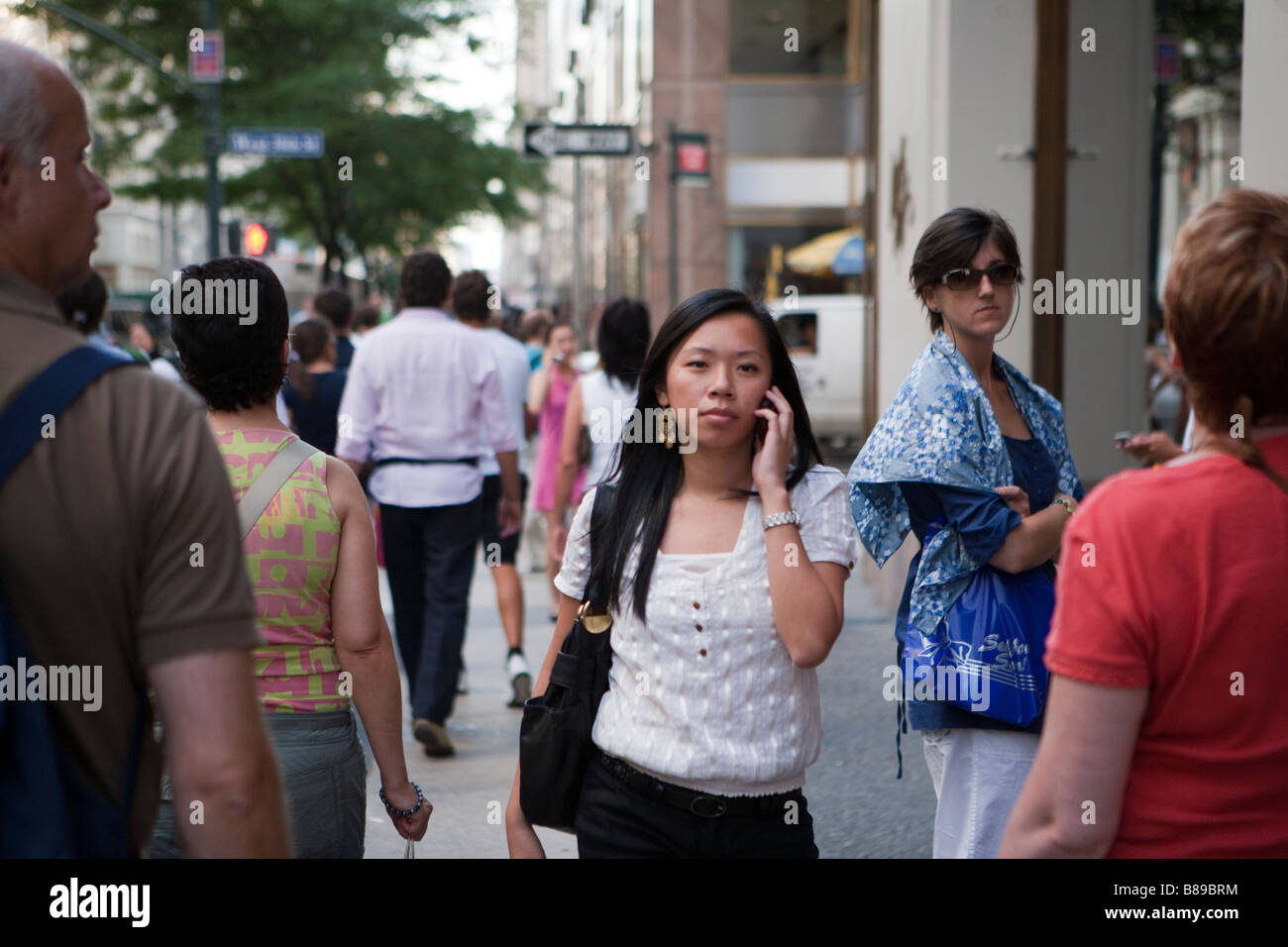 asian woman walking on the street talking on the phone Stock Photo - Alamy