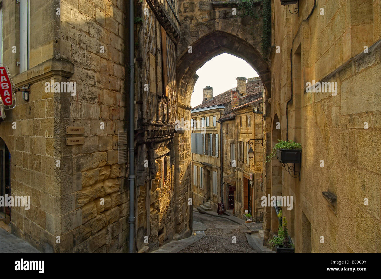 St Emilion ancient backstreet with archway and 'Tabac' sign, southwest ...