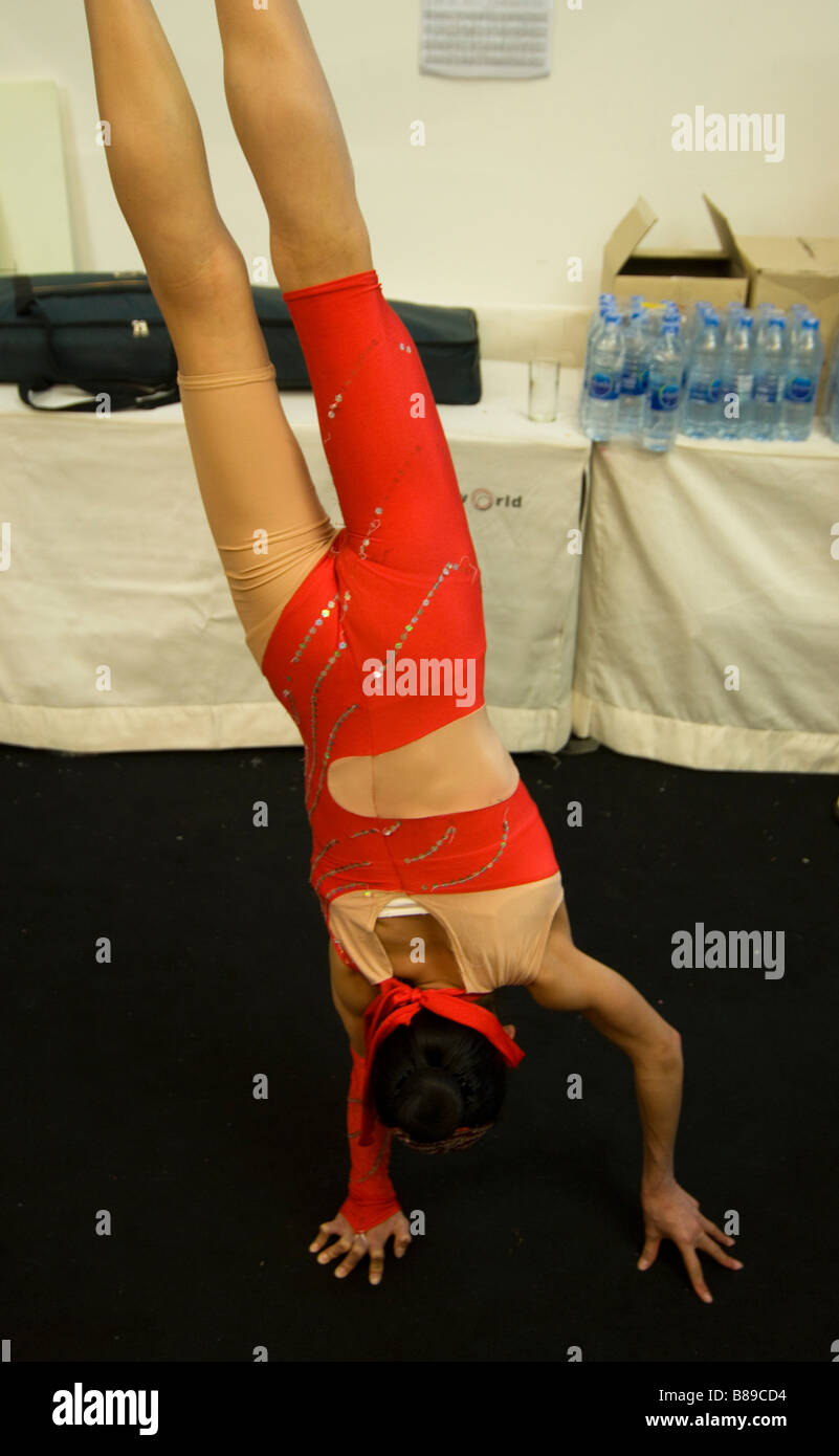 Chinese acrobat practicing a handstand backstage at Chinese New Year ...