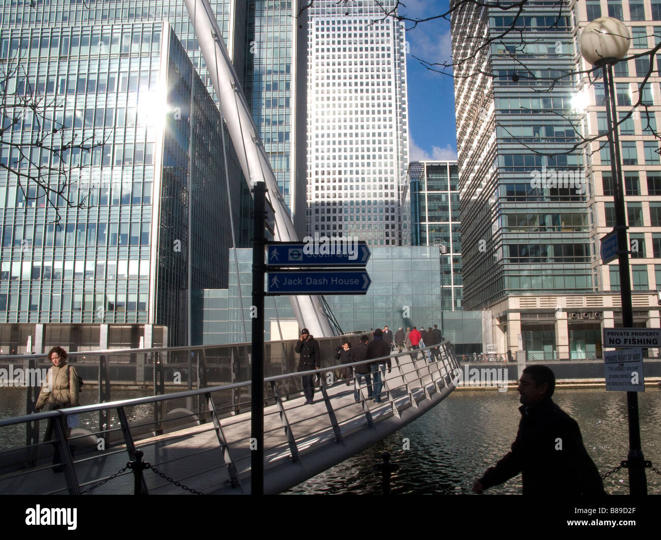Office Workers walk over South Quay foot bridge Stock Photo - Alamy