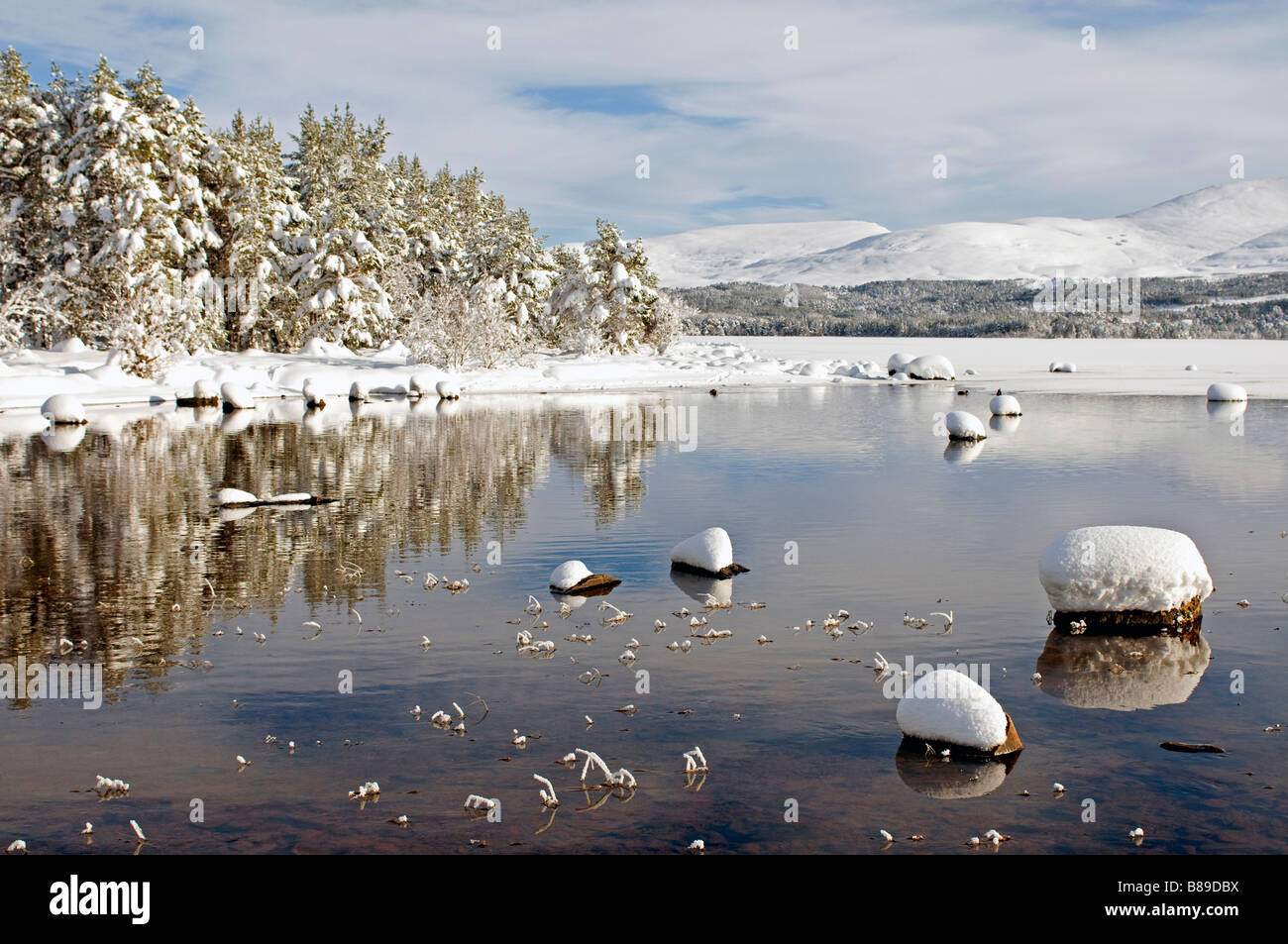 The Cairngorm mountains from frozen Loch Morlich in the foothills of ...