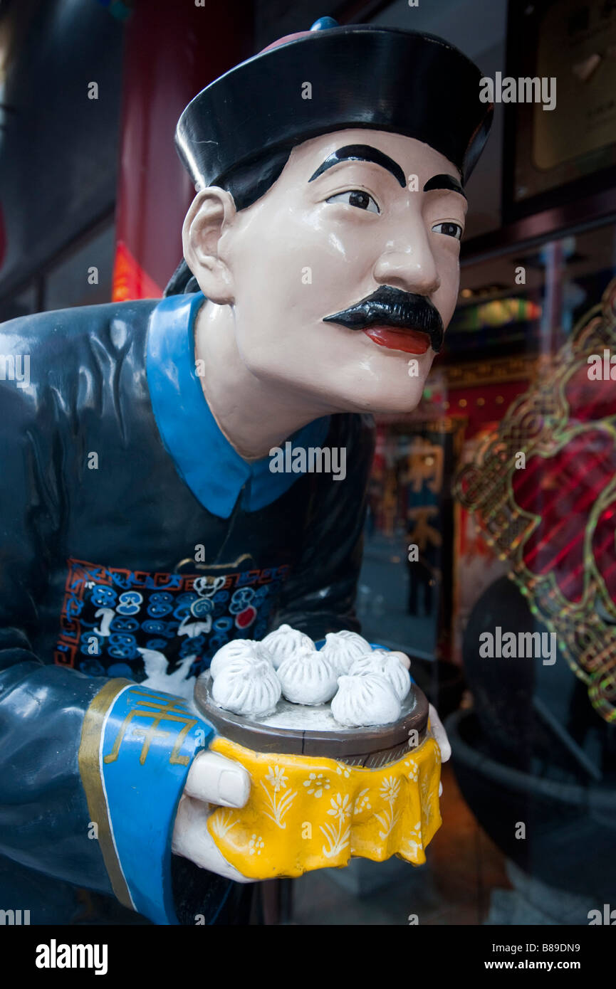 Life size statue of waiter in traditional costume outside dumpling ...