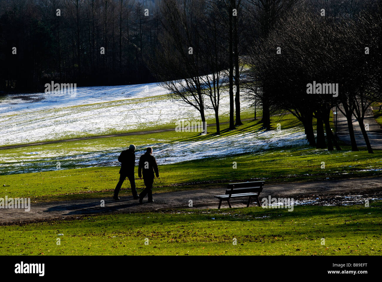 Two men walking on a cold afternoon Stock Photo - Alamy