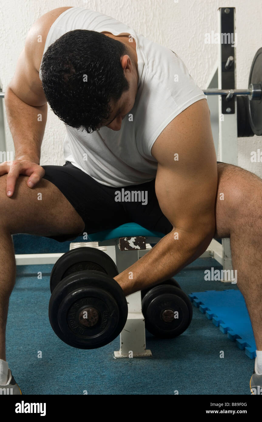 Man training his biceps in the gym Stock Photo - Alamy