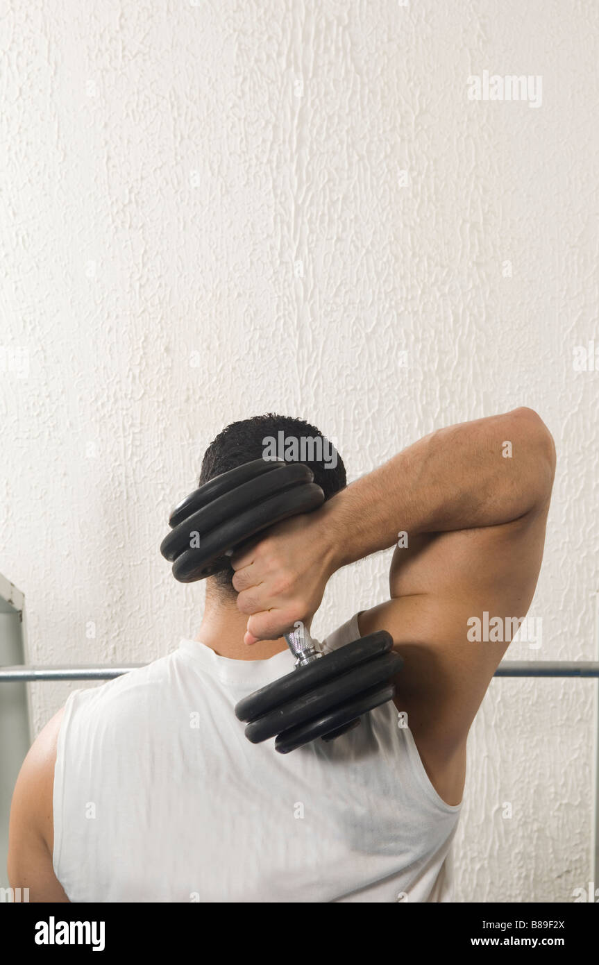 Man dumbbell extension gym hi-res stock photography and images - Alamy