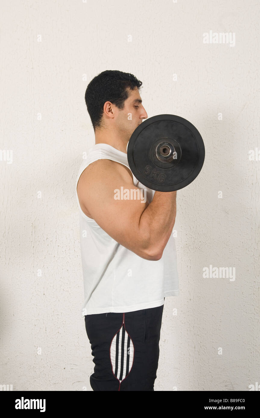 Man training biceps curls in the gym Stock Photo - Alamy