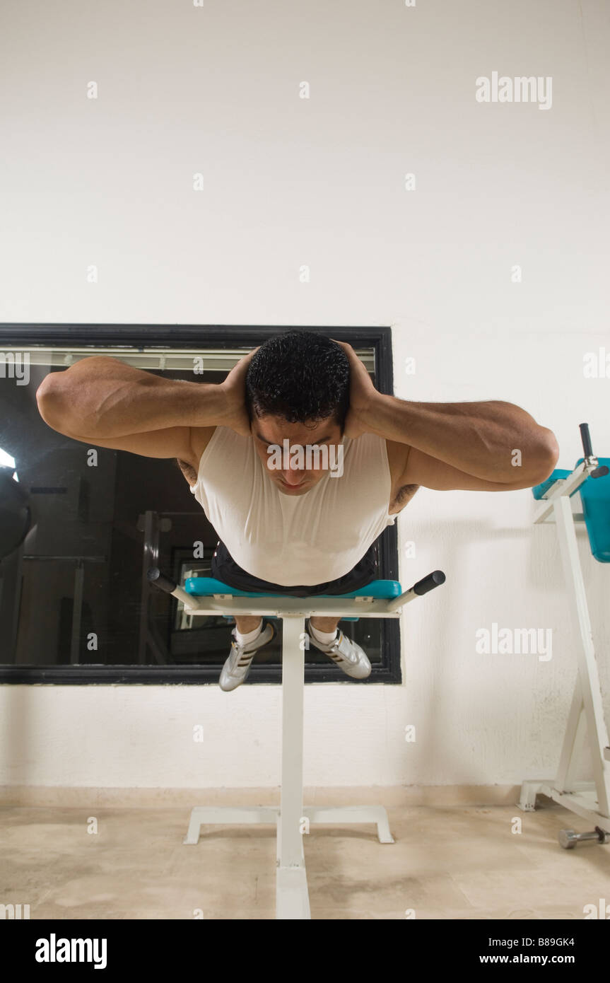 Man doing low back extension exercise in the gym Stock Photo - Alamy