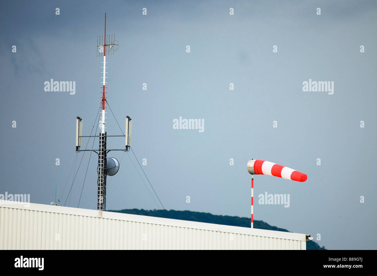airport devices antenna and windsock against heavy sky Stock Photo - Alamy