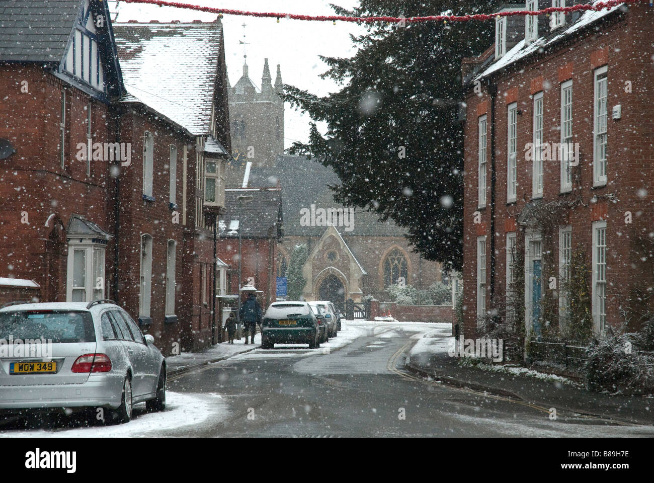 Wintery scene in the falling snow looking down Church Street in Tenbury ...