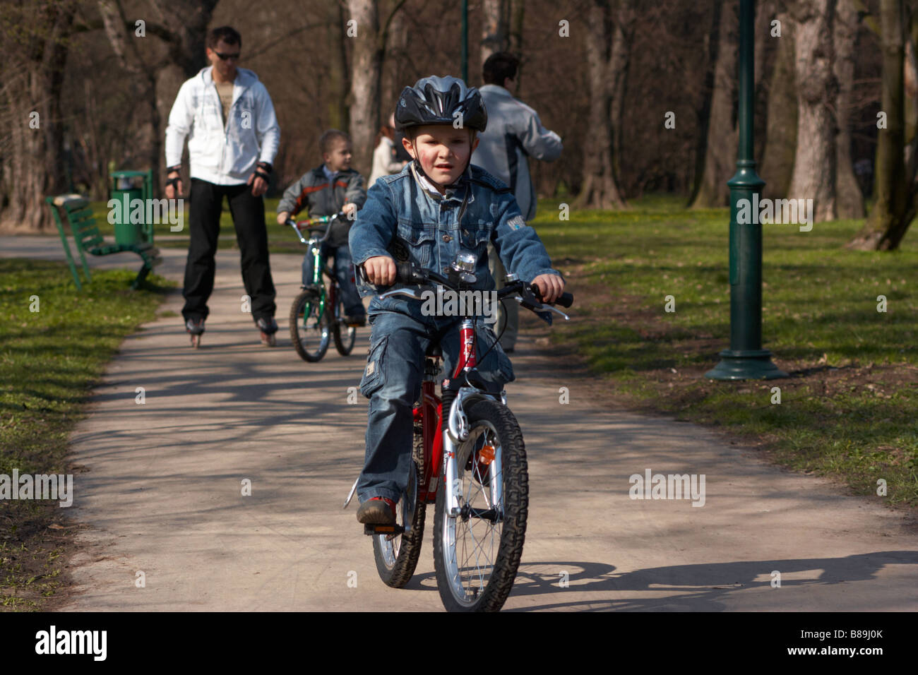 A young boy riding a bicycle Stock Photo - Alamy