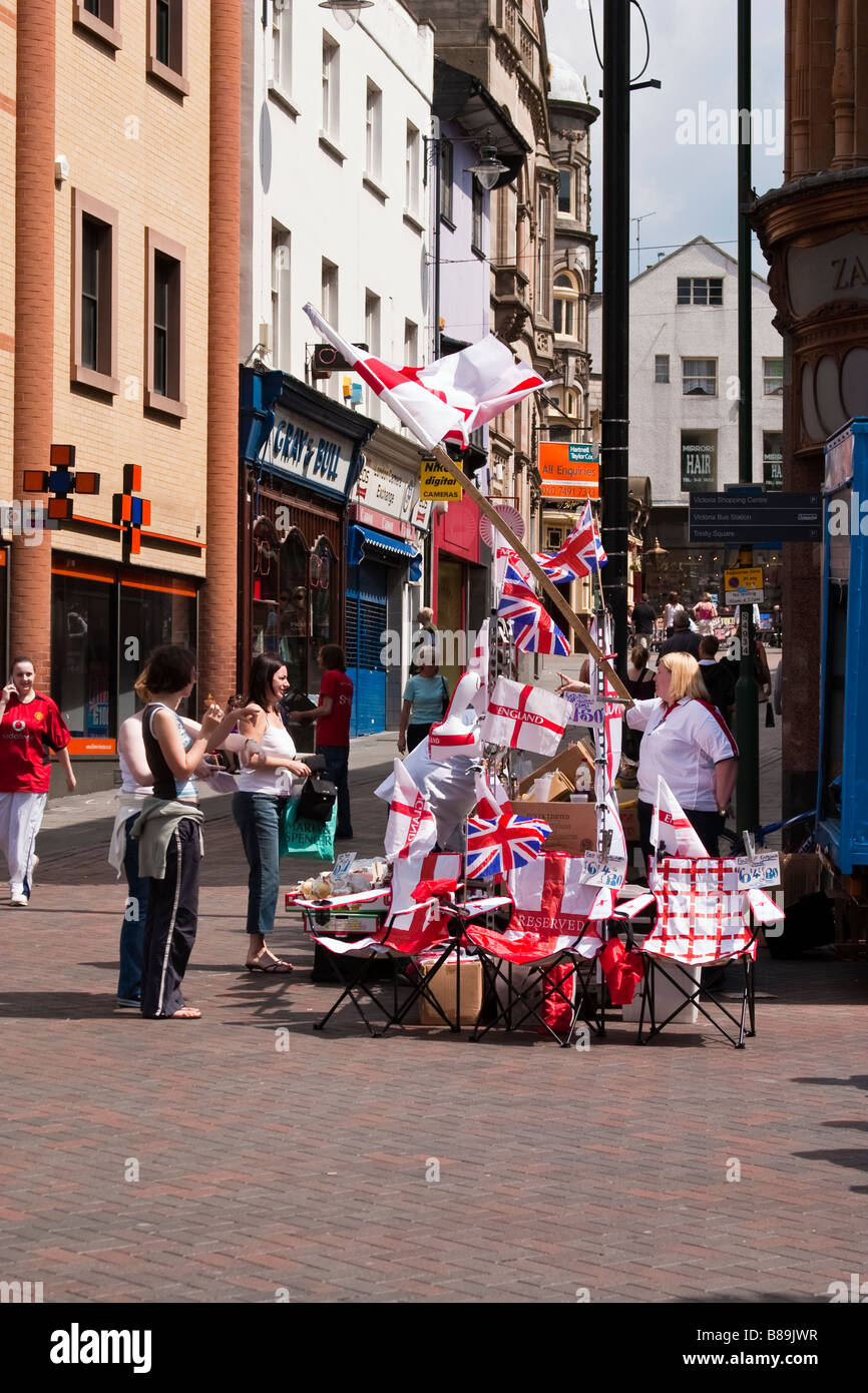 View of market stall holder in Nottingham selling football souvenirs ...
