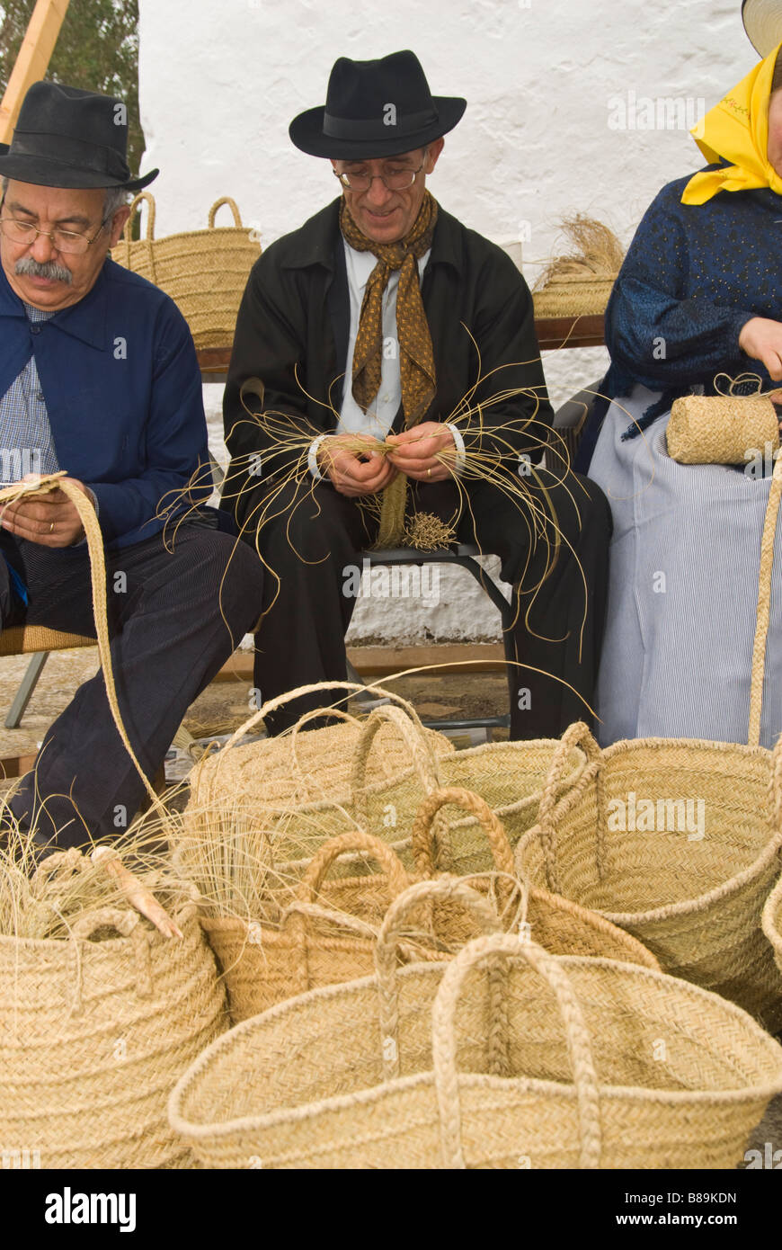 Craftsmen in traditional costume making baskets out of esparto at the ...