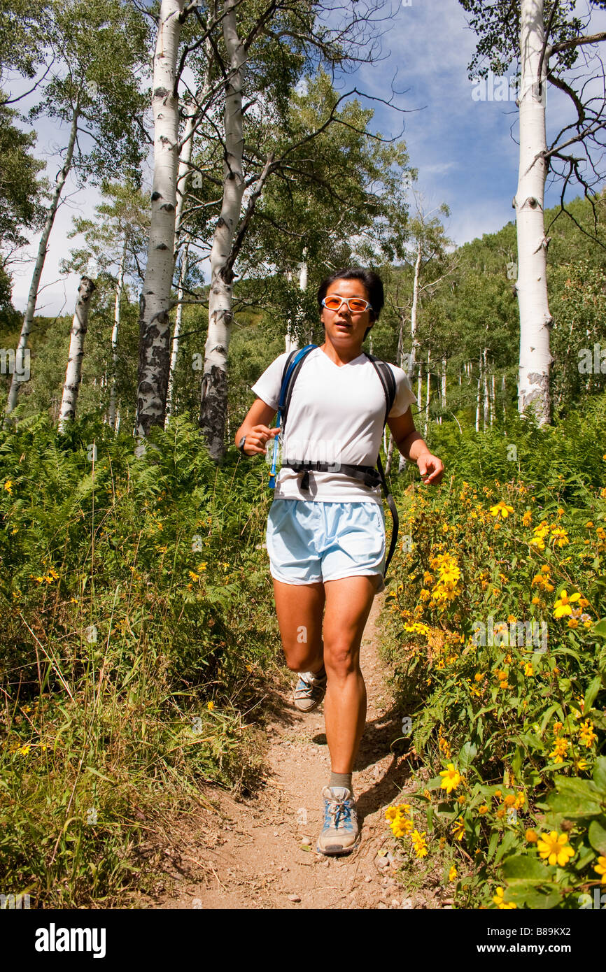 Women trail runs on a Spring Creek trail in Steamboat Springs Colorado ...