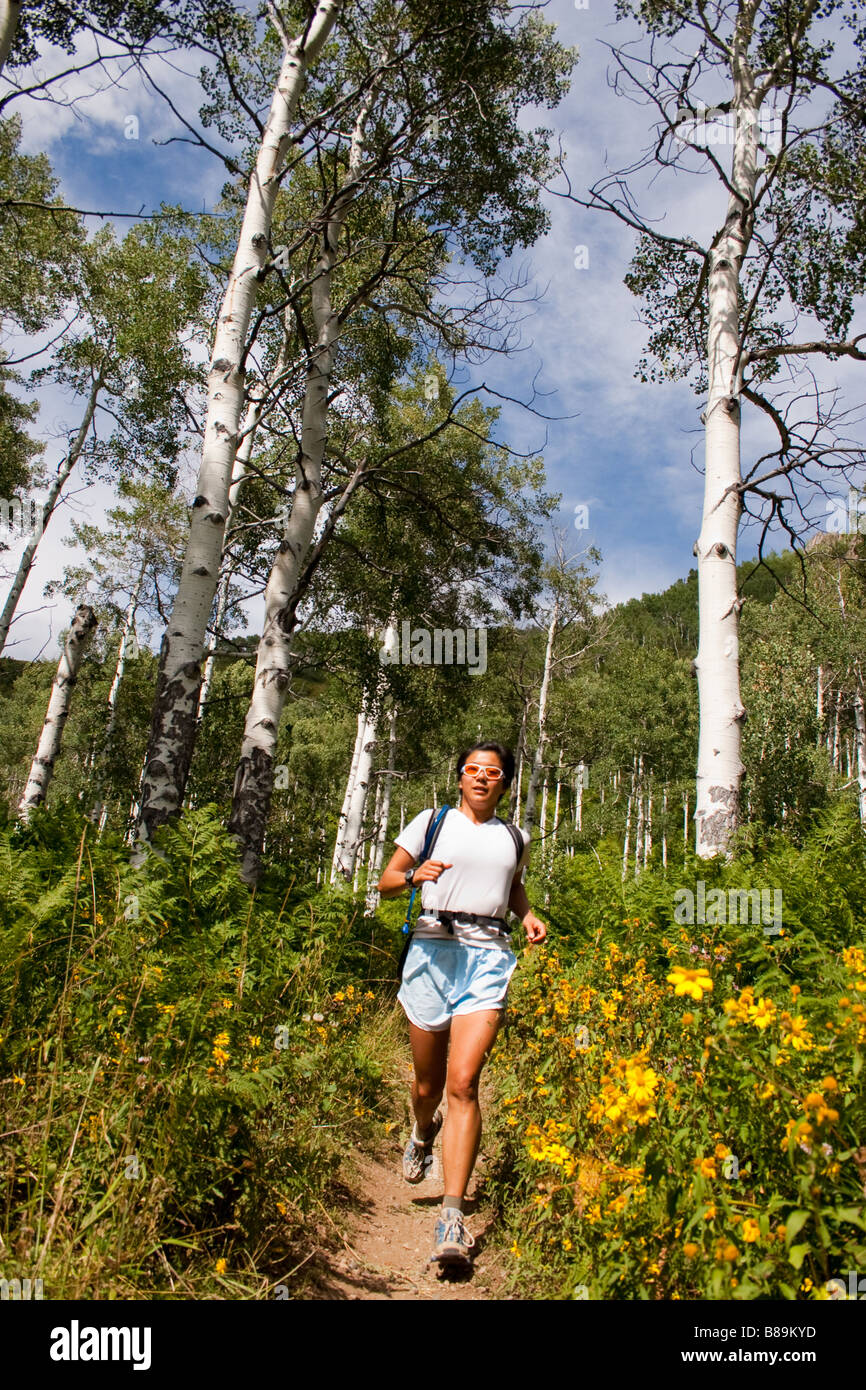 Women trail runs on a Spring Creek trail in Steamboat Springs Colorado ...