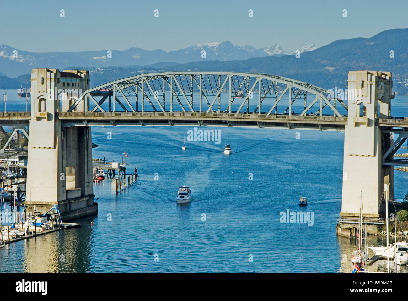 Bridge in Vancouver, British Columbia with view of the mountains beyond ...
