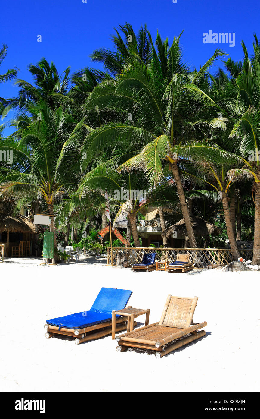 Beach chairs and table on the beach Stock Photo - Alamy