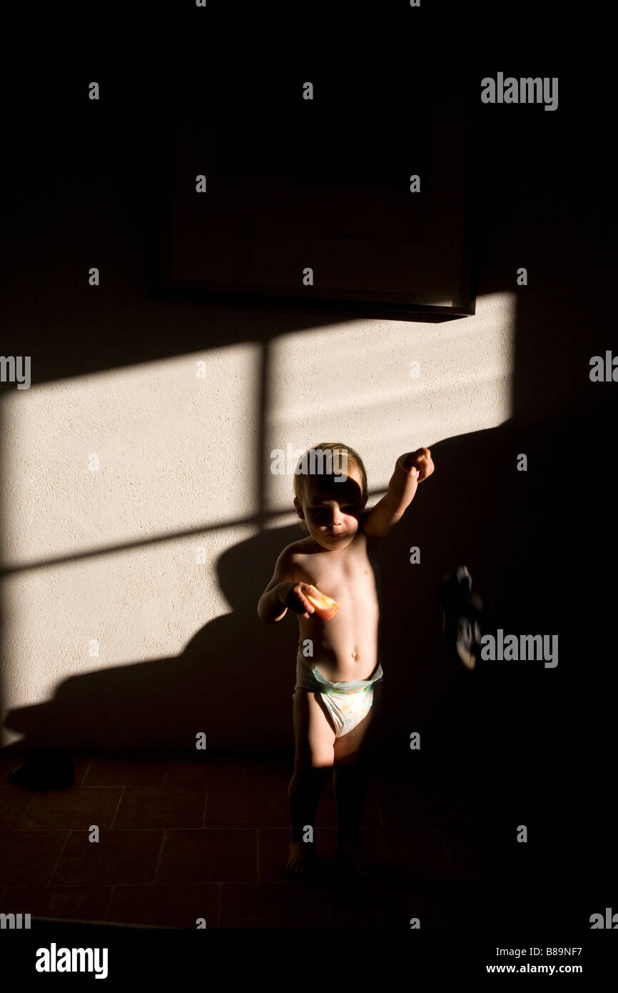 Toddler playing in shadows Stock Photo - Alamy