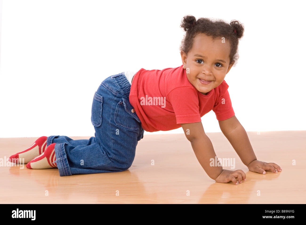 Adorable african baby crawl over wooden floor Stock Photo - Alamy