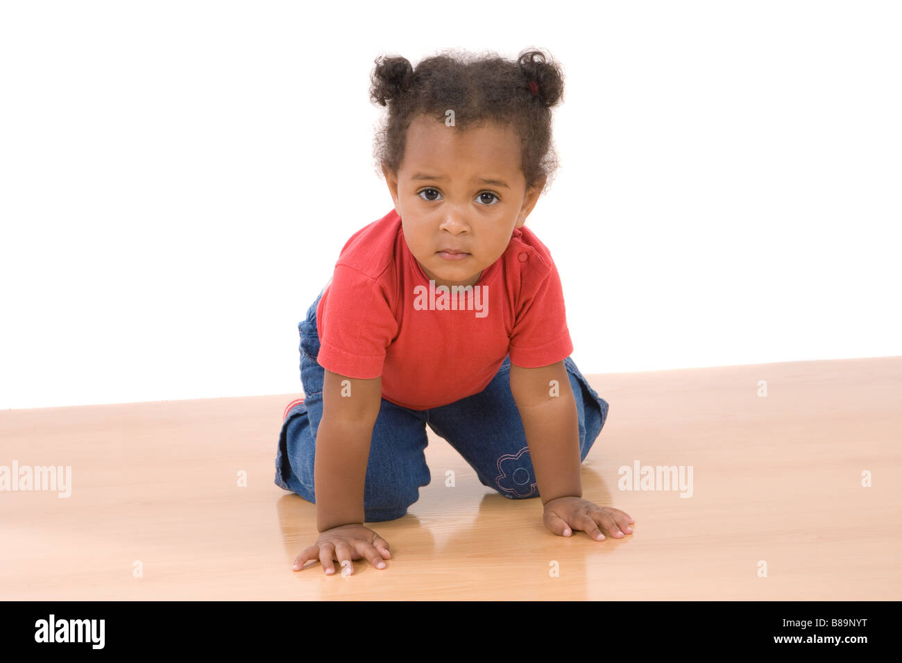 Adorable african baby crawl over wooden floor Stock Photo - Alamy