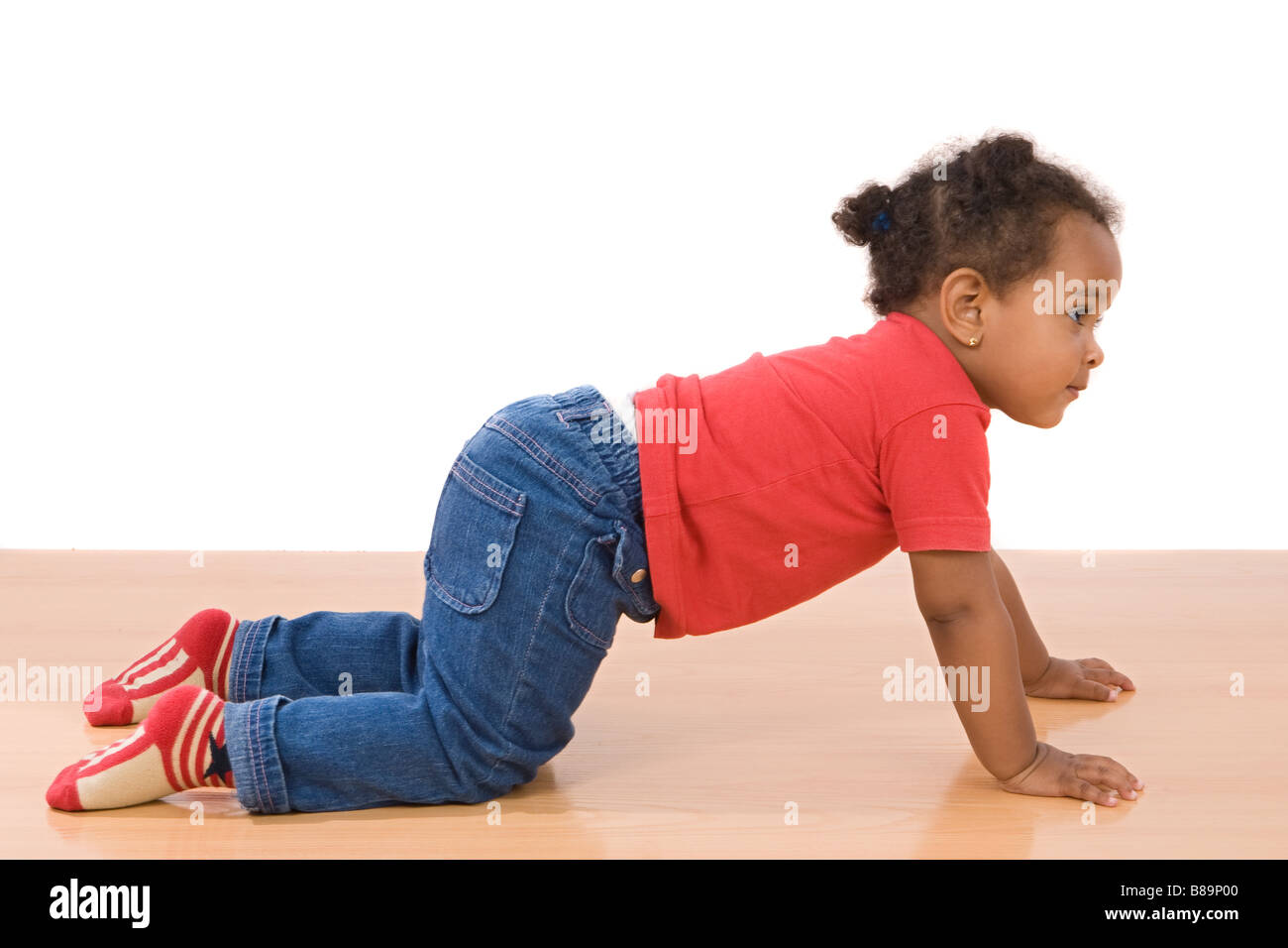 Adorable african baby crawl over wooden floor Stock Photo - Alamy