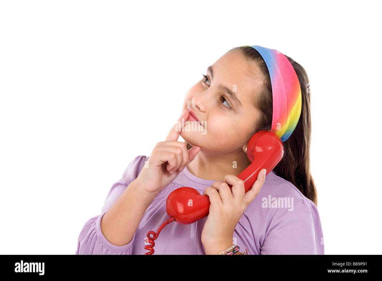 Beautiful girl with red telephone thinking on a over white background ...