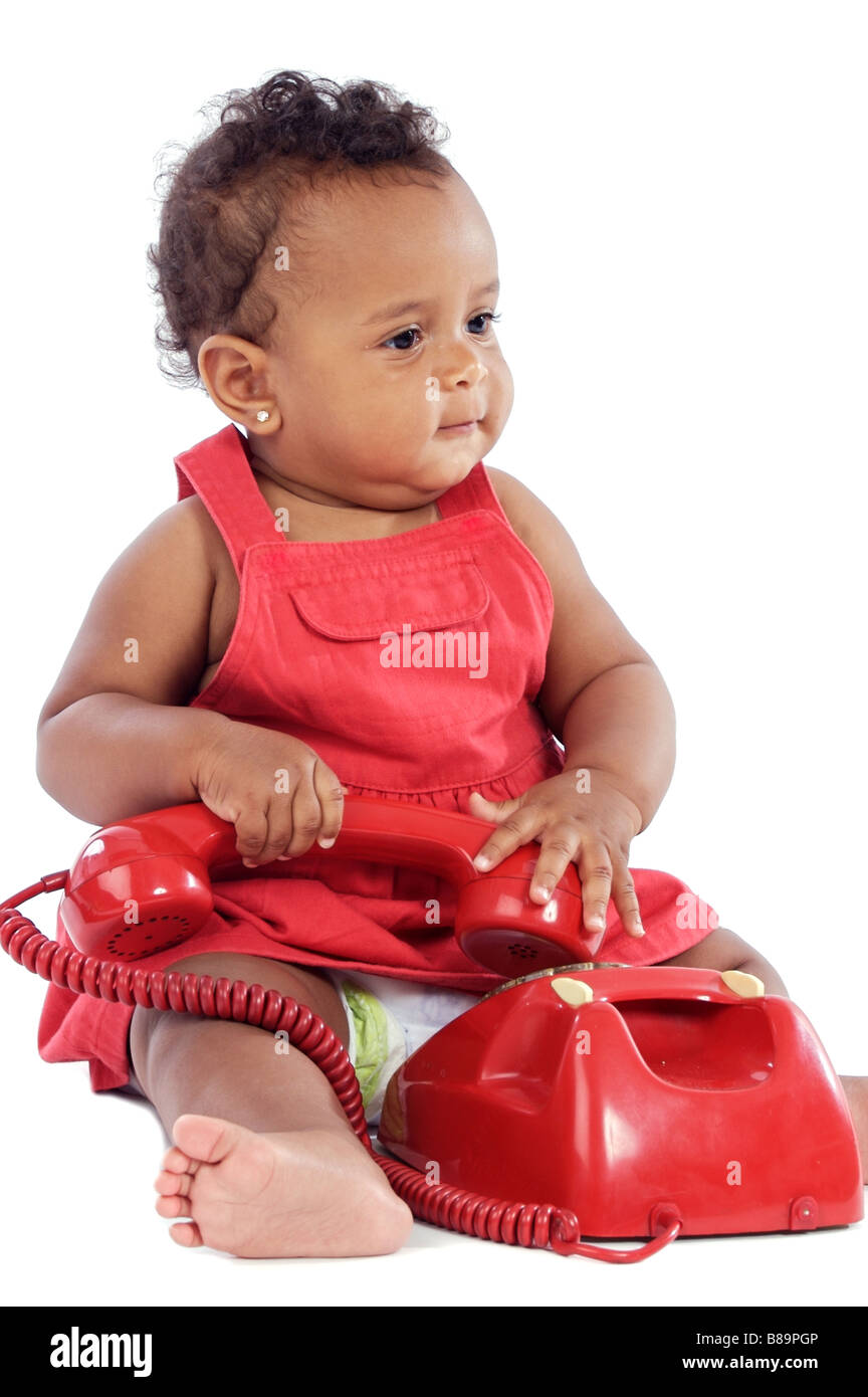 Baby with red phone a over white background Stock Photo - Alamy
