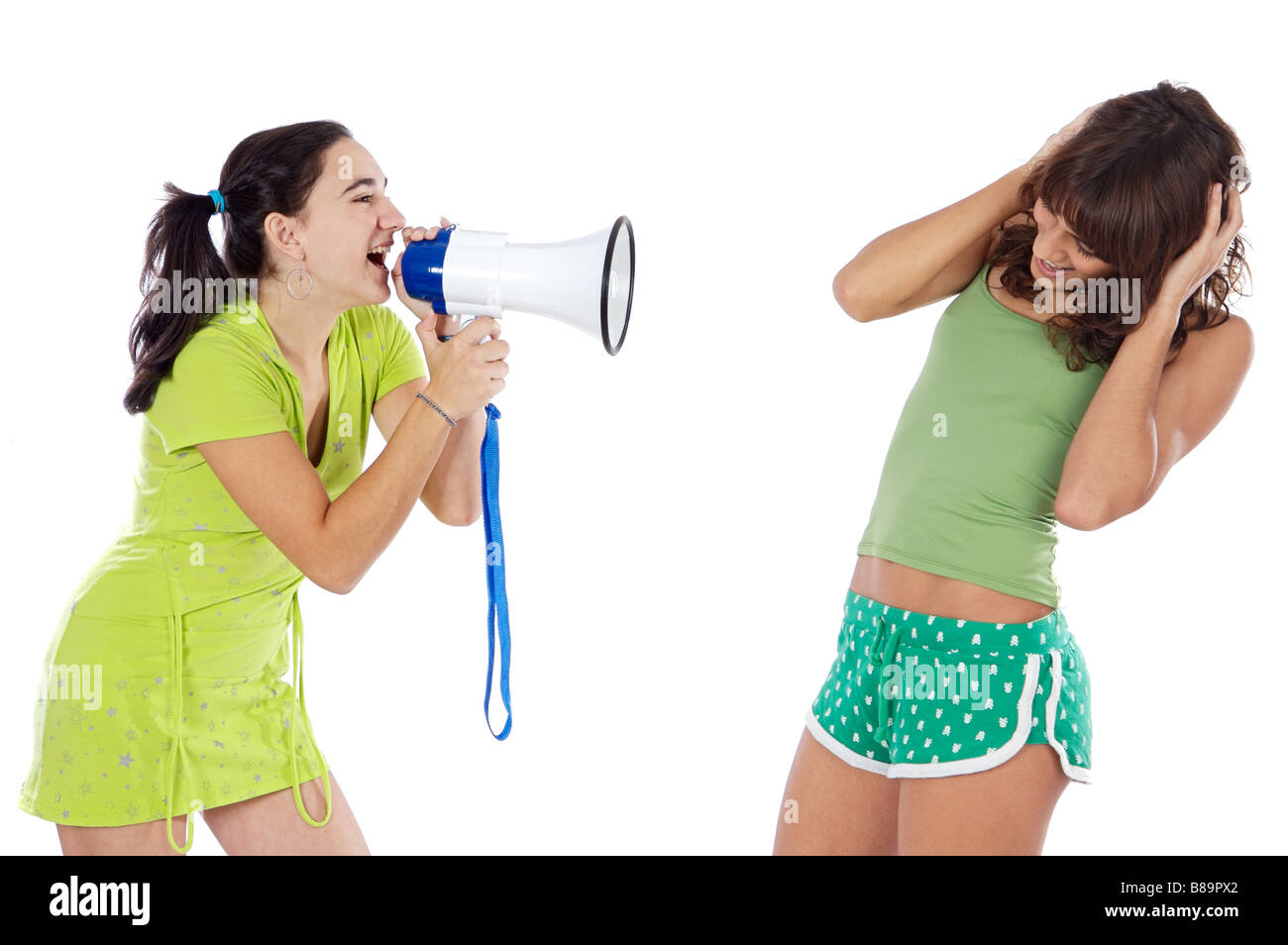 Teen Girl with megaphone shouting to another girl Stock Photo - Alamy