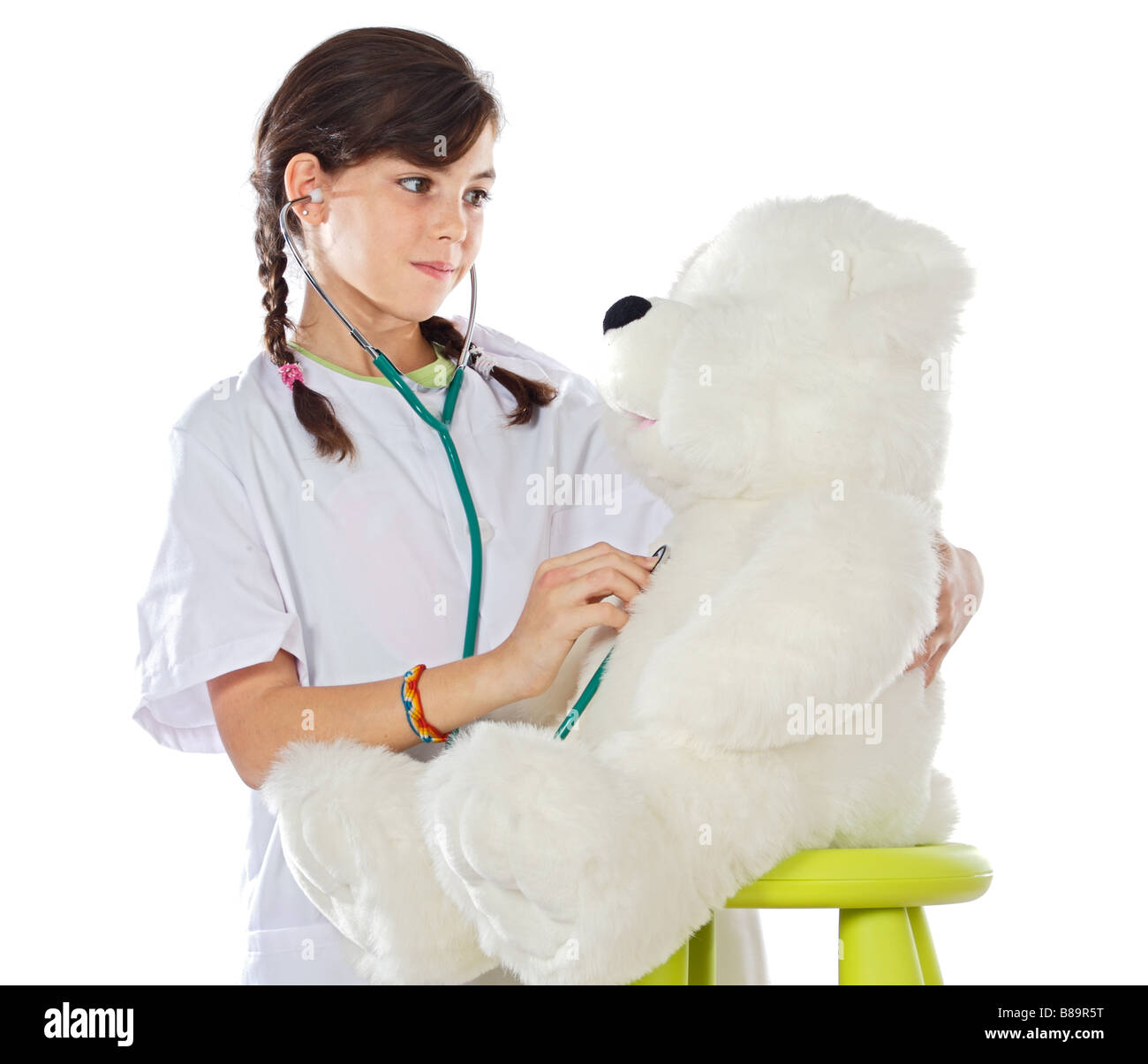Little doctor examining her bear a over white background Stock Photo ...