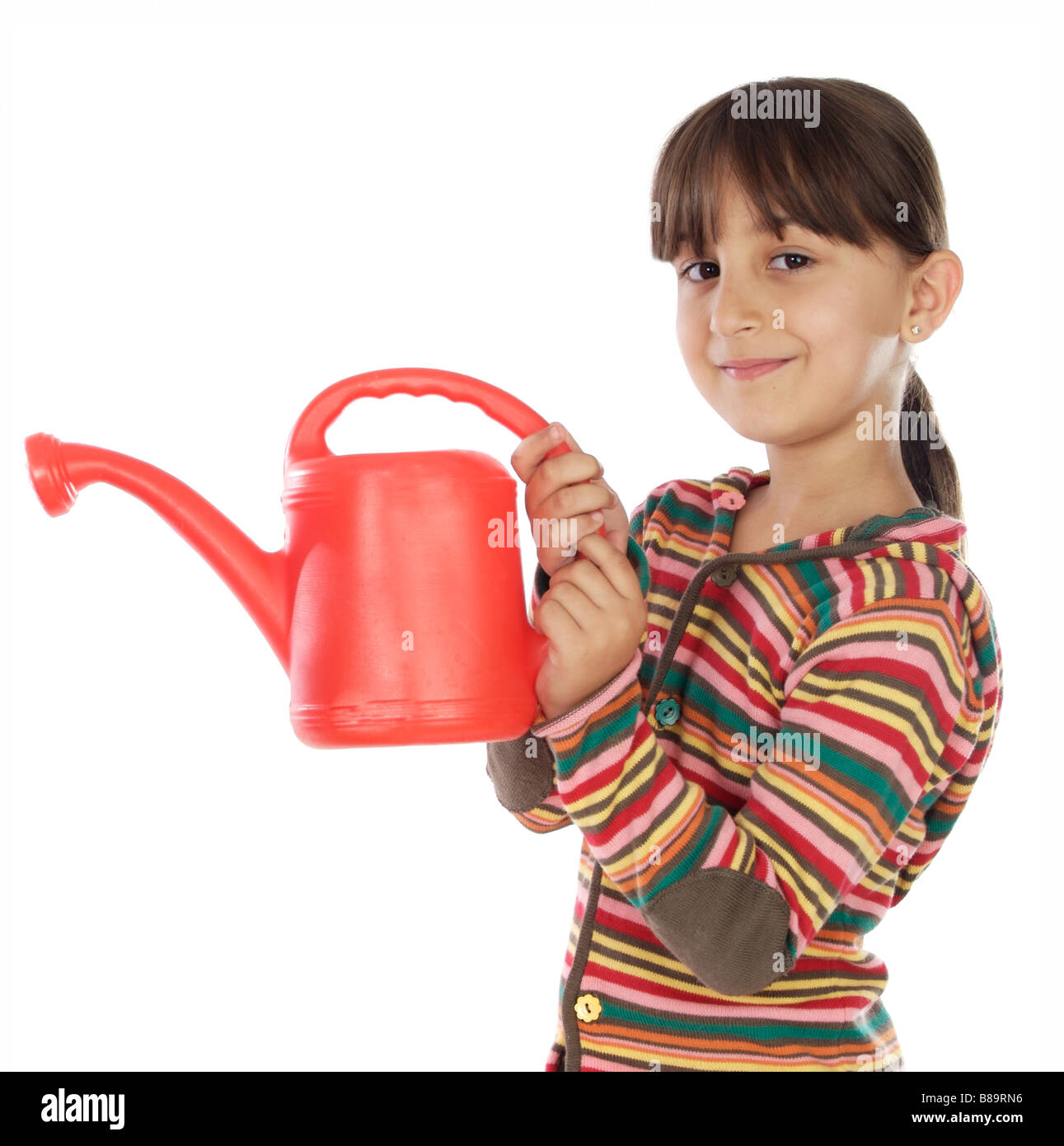 Adorable girl watering a over white background Stock Photo - Alamy
