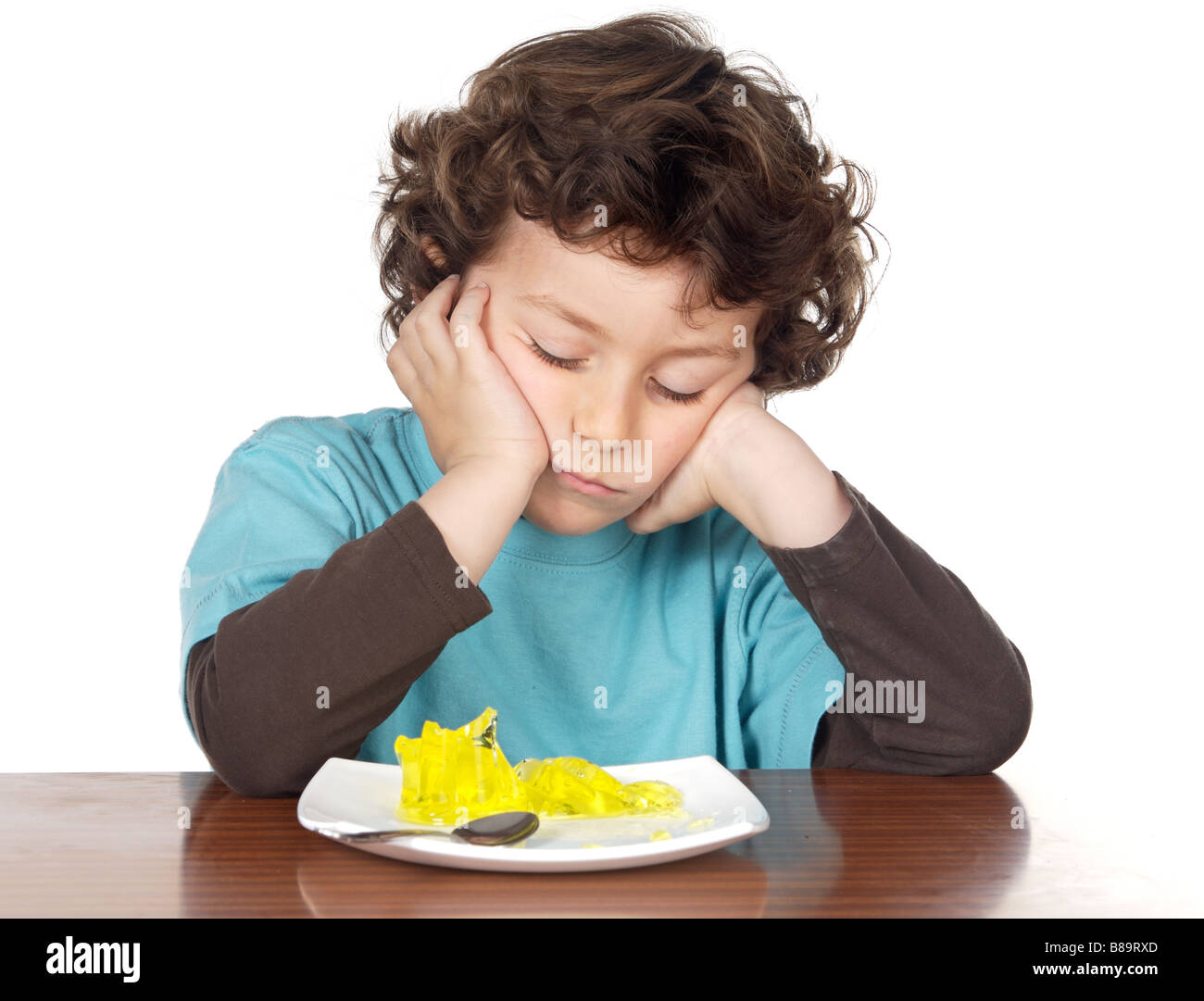 child eating boring food a over white background Stock Photo - Alamy