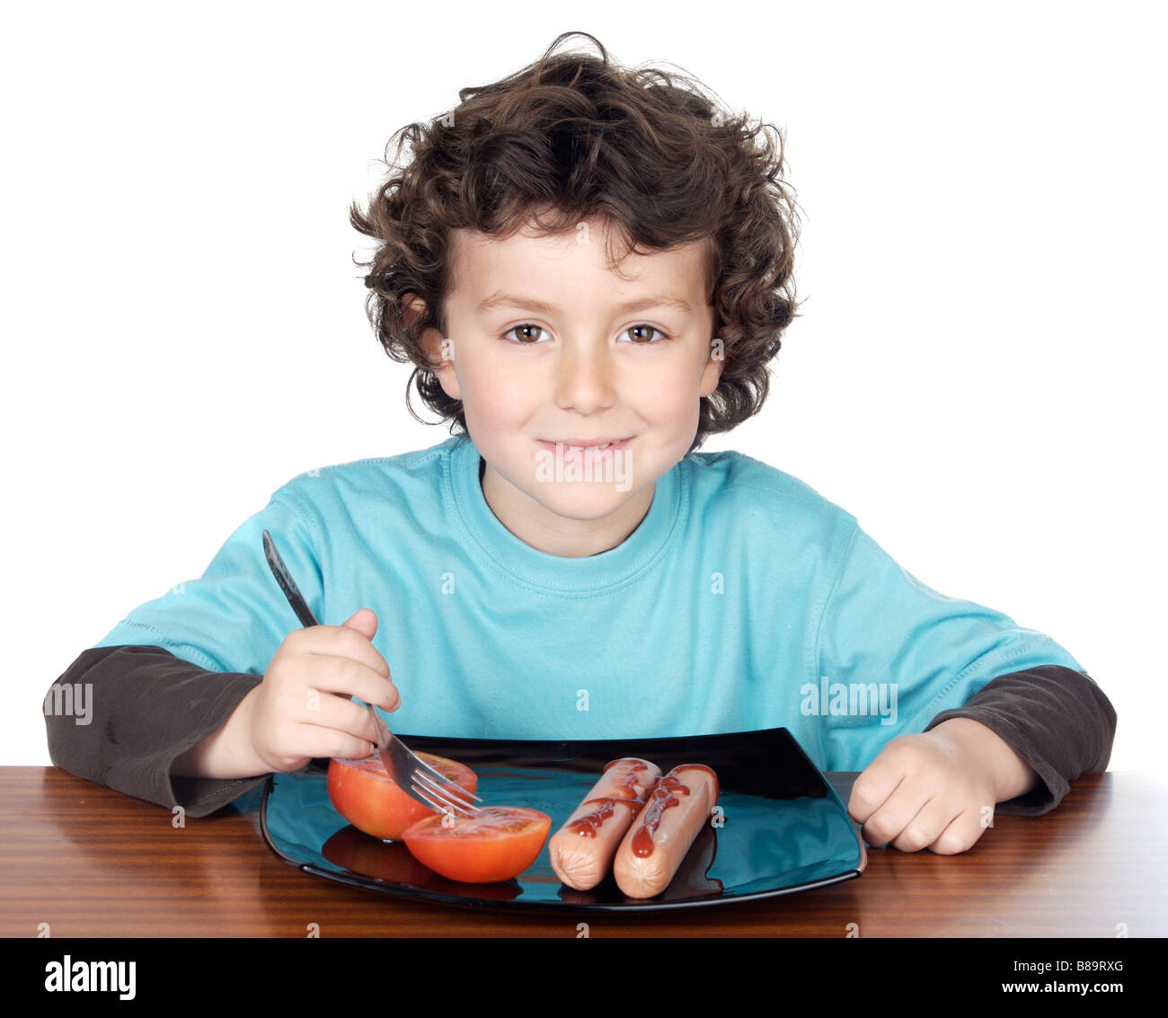 Adorable child eating a over white background Stock Photo - Alamy