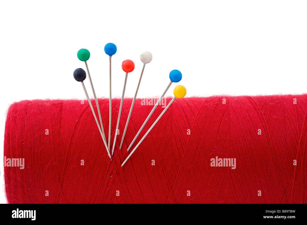 red thread ball of yarn a over white background Stock Photo - Alamy