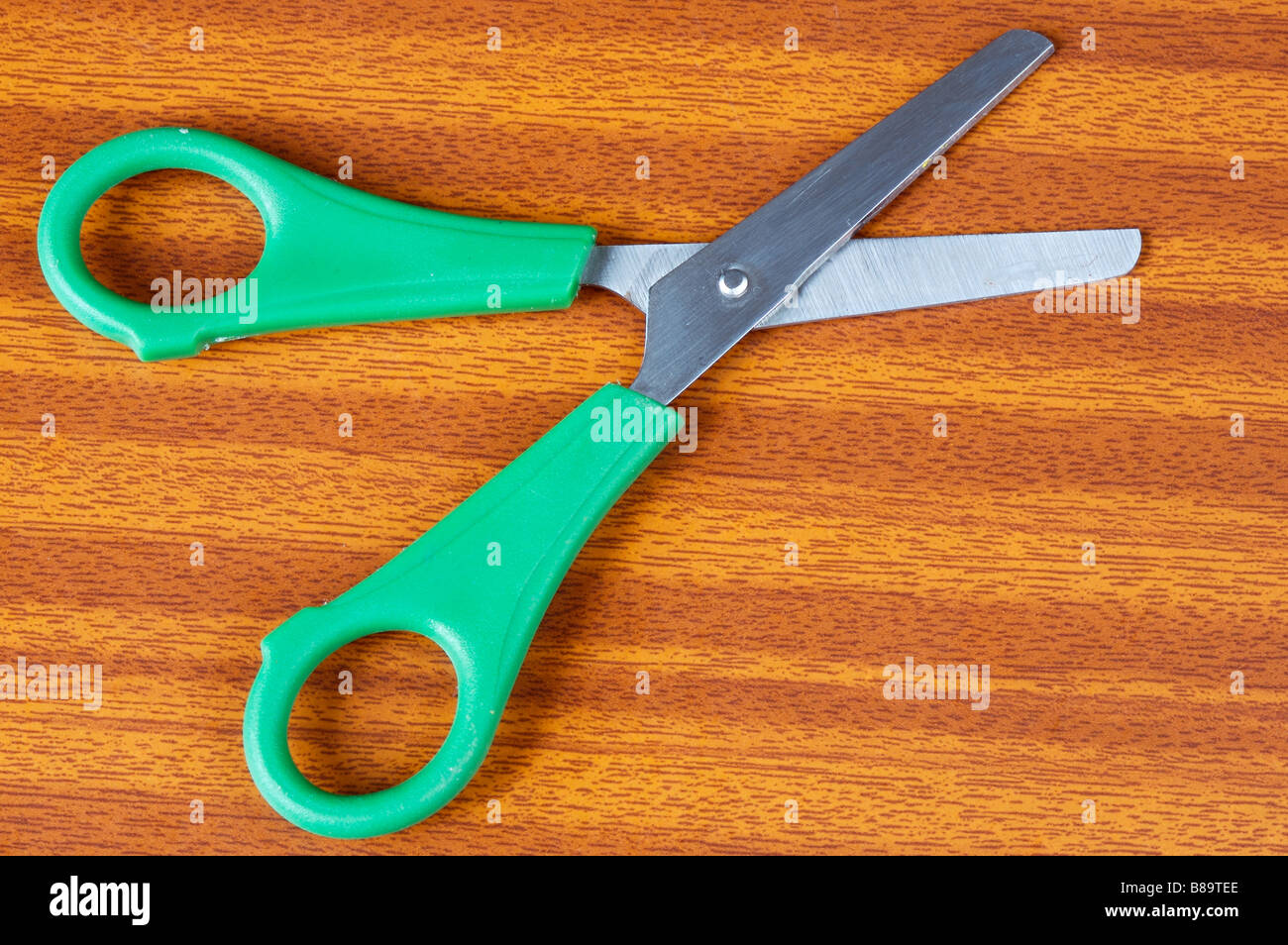 photo of green scissors on a table Stock Photo - Alamy