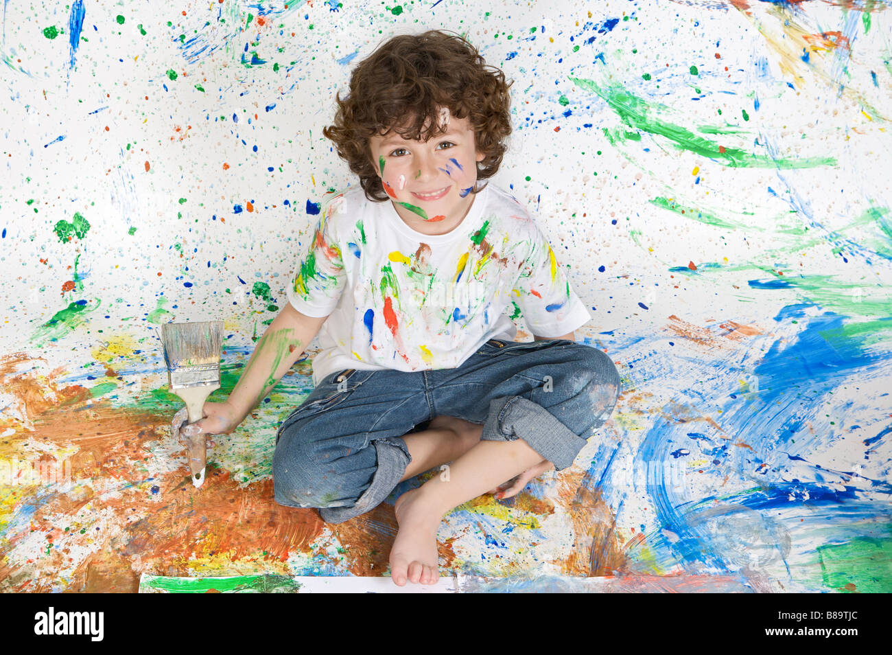 Handsome boy playing with painting with the background painted Stock ...