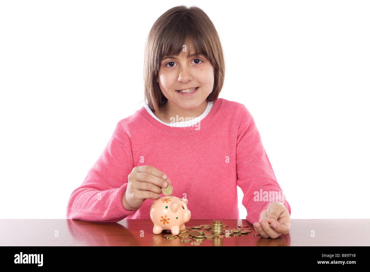 Adorable girl with money box a over white background Stock Photo - Alamy