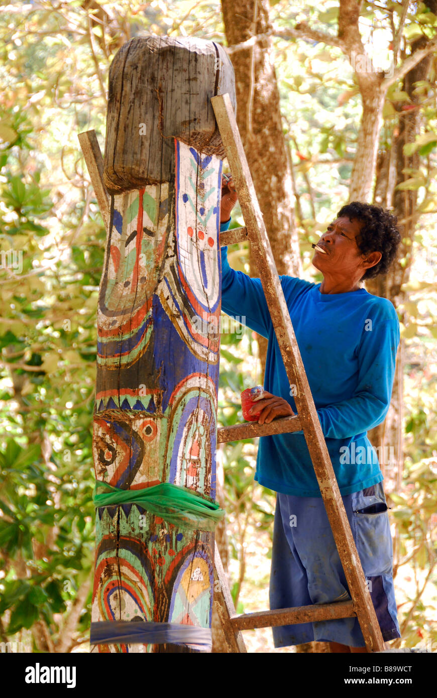 Moken sea gypsy man painting Lorbow(moken's god) before annual merit ...