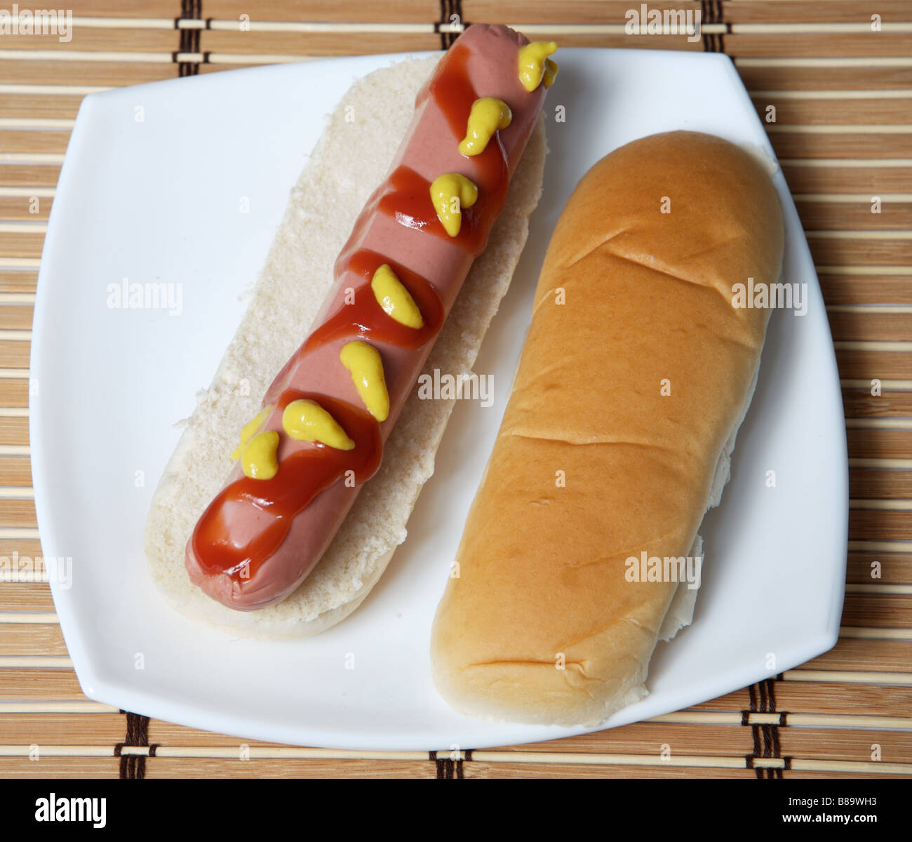 a hot dog in a white plate Stock Photo - Alamy